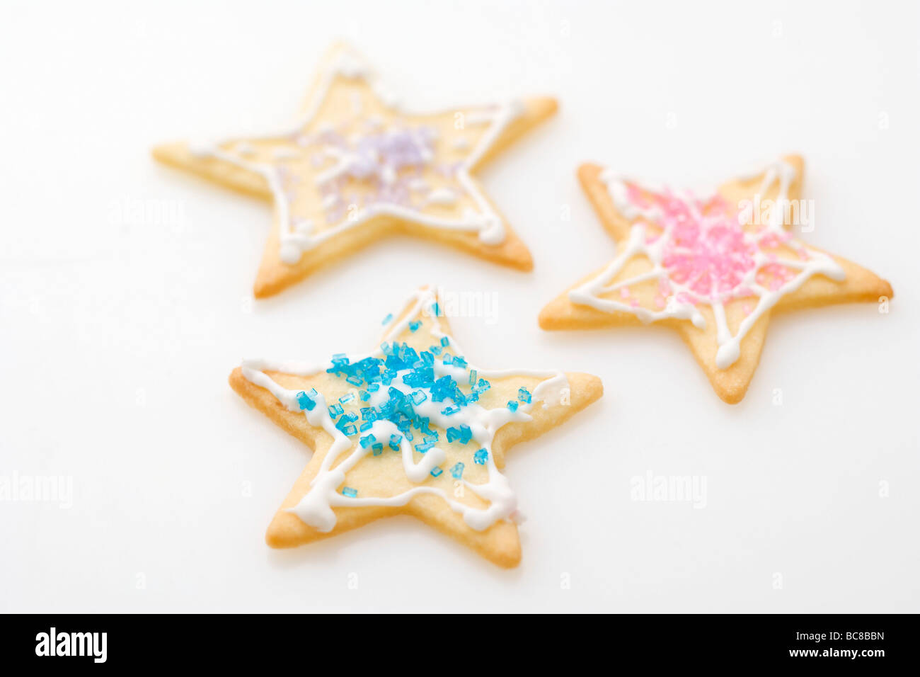 Three star biscuits decorated with coloured sugar Stock Photo - Alamy
