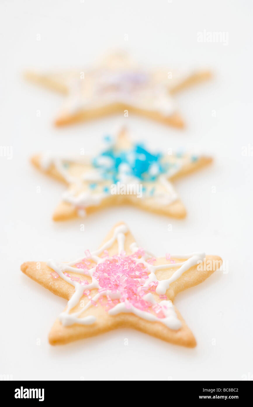 Three star biscuits decorated with coloured sugar Stock Photo - Alamy