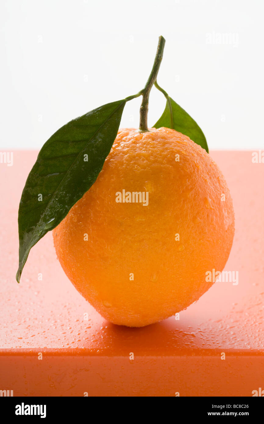 Orange with stalk and leaf Stock Photo - Alamy
