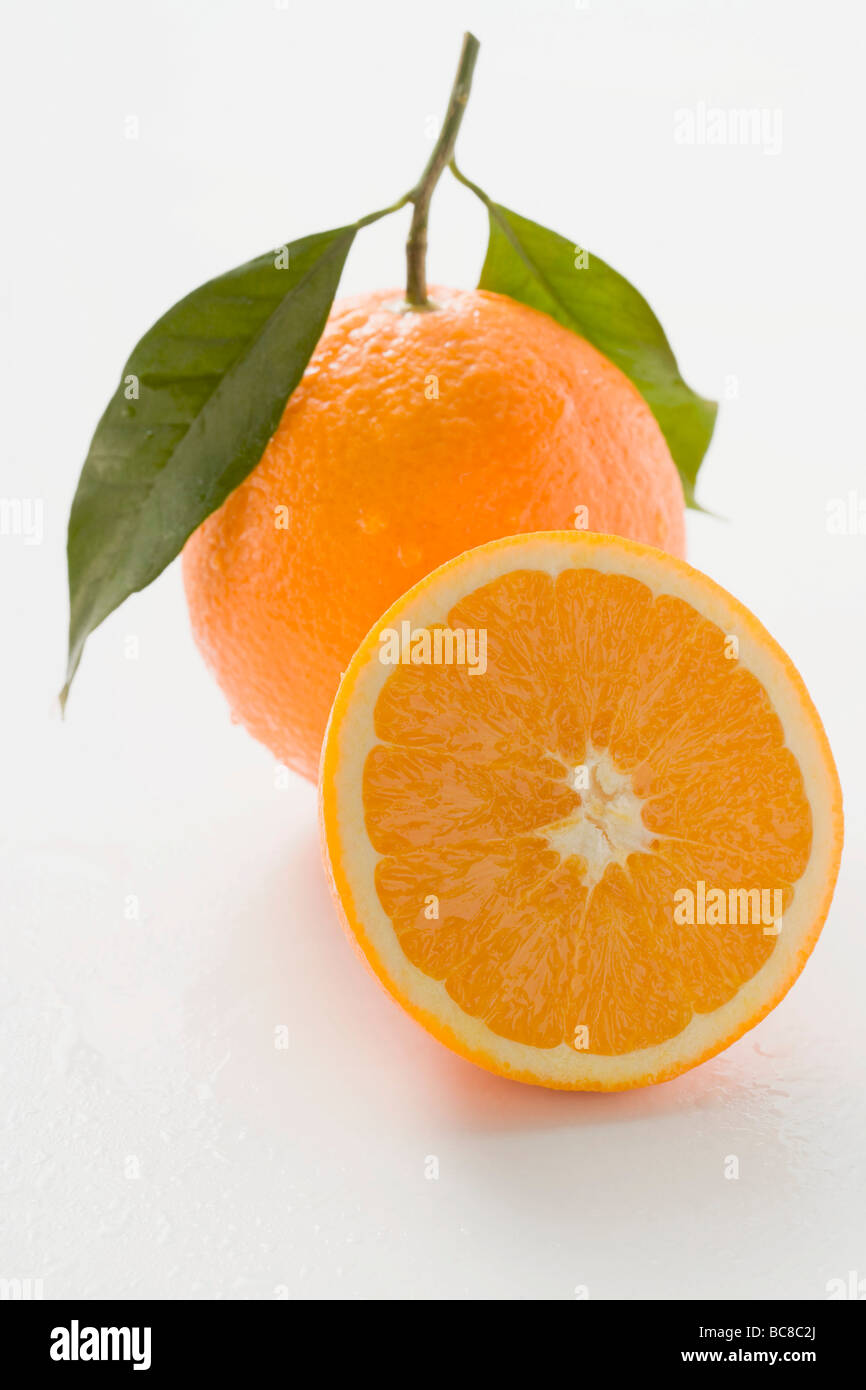 Orange with stalk and leaf, half an orange Stock Photo - Alamy