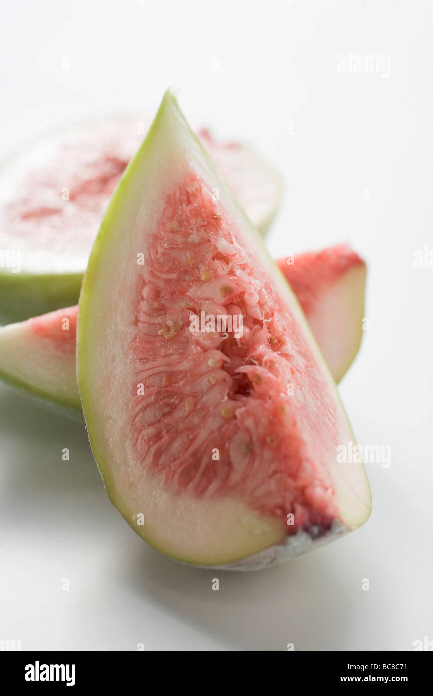 Fresh fig, cut into one half and two quarters Stock Photo - Alamy