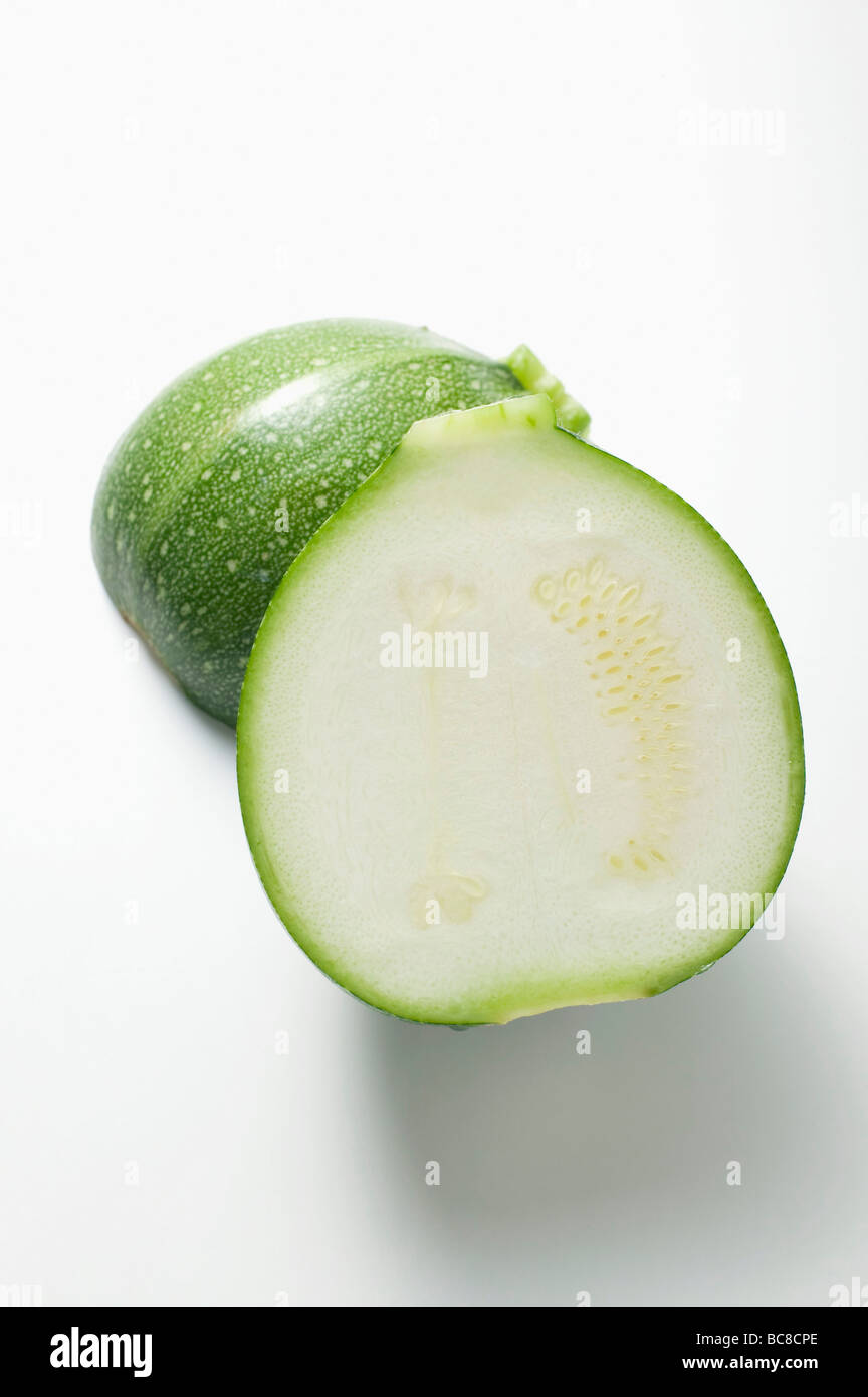 Two halves of a round courgette Stock Photo - Alamy