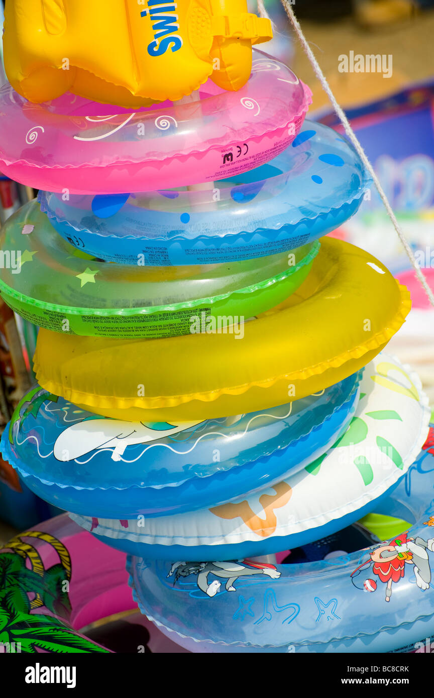 Colourful inflatable rubber rings for sale at the seaside Stock Photo ...