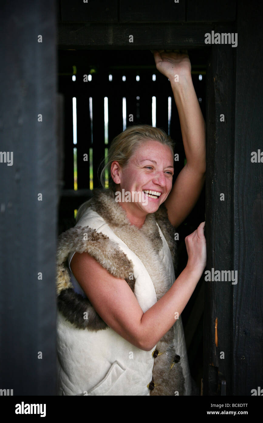 Blonde white woman cowgirl smiling and laughing at a barn Stock Photo ...