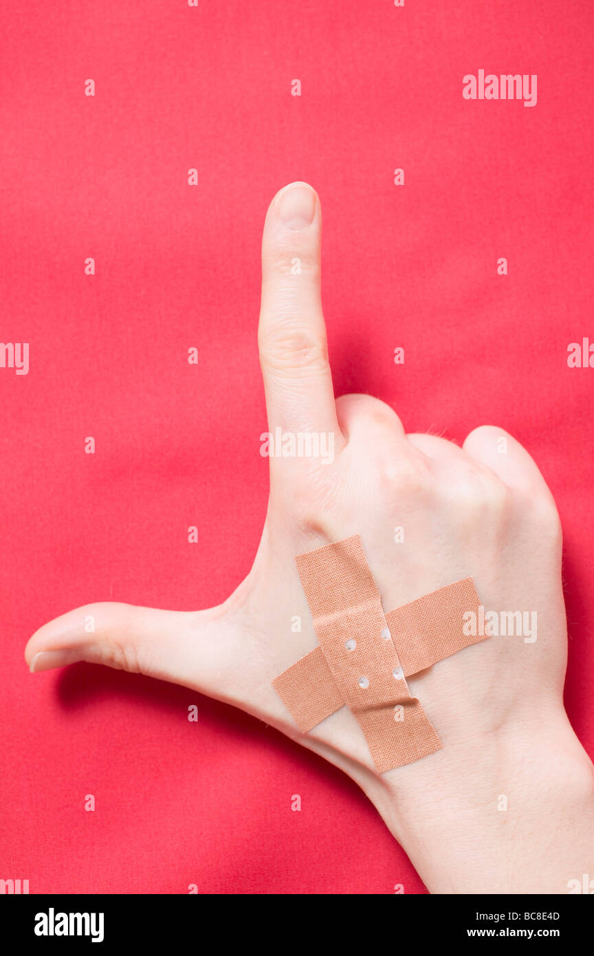 Hand with crossed sticking plasters Stock Photo - Alamy