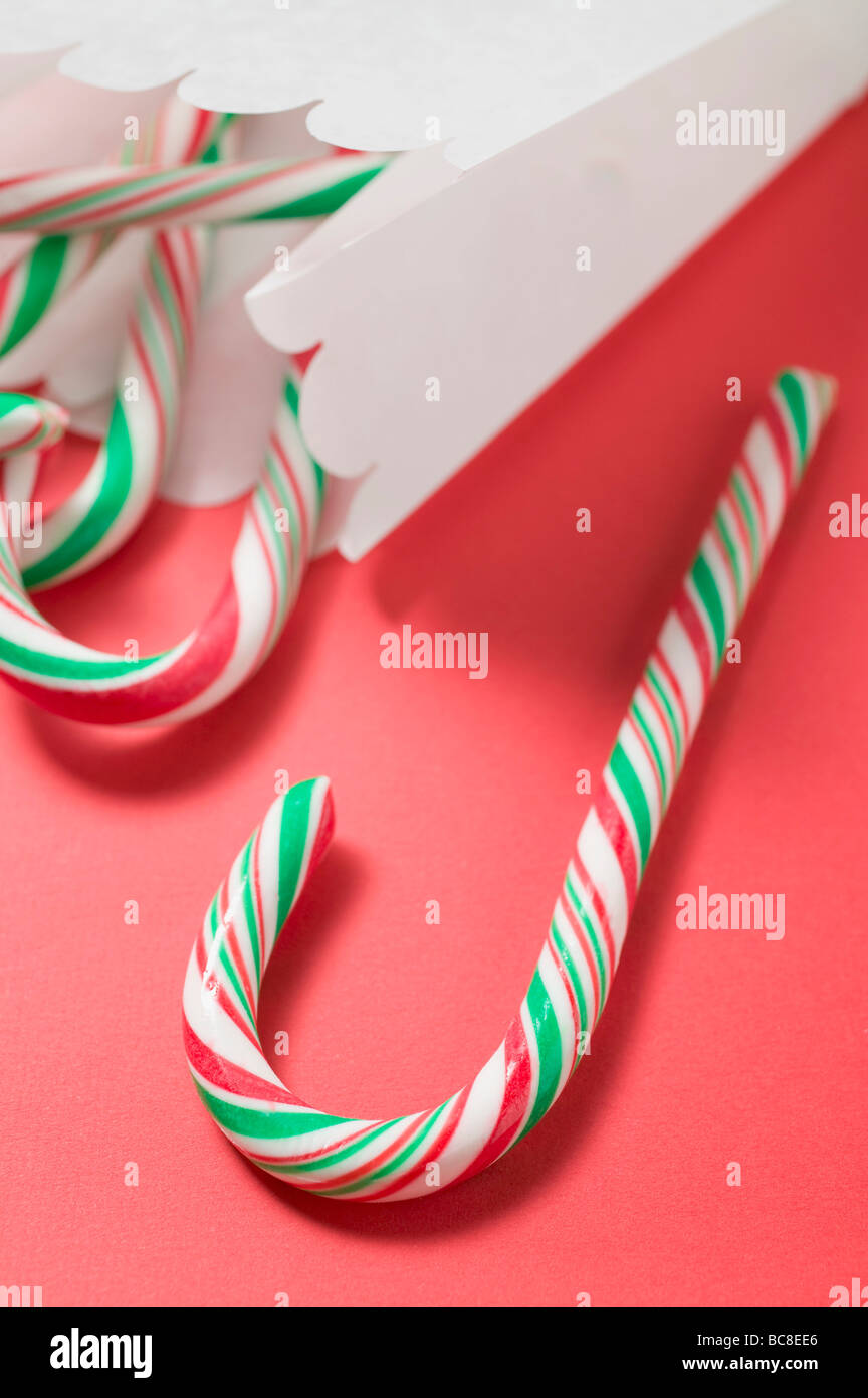 Candy canes in and beside paper bag Stock Photo - Alamy