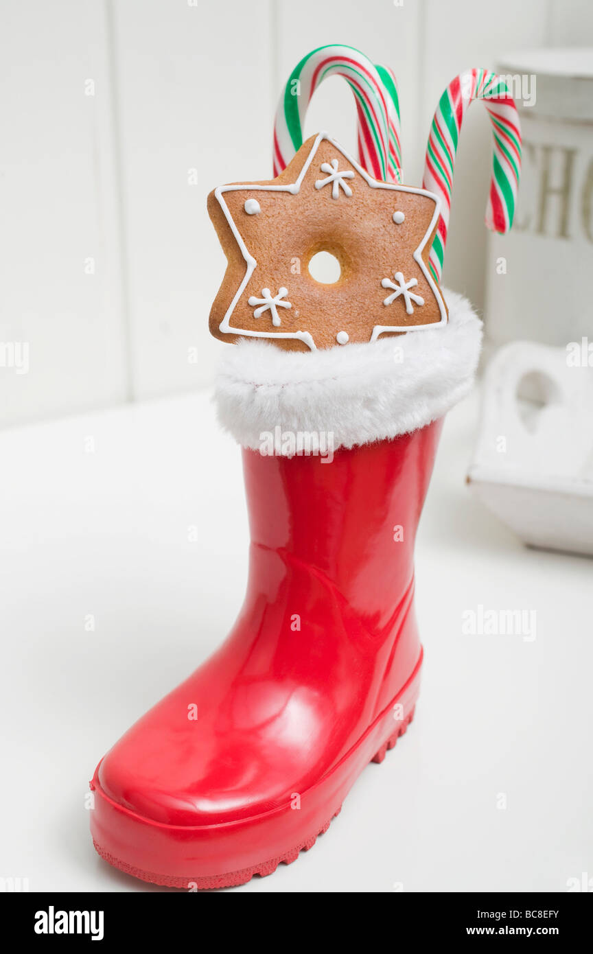 Gingerbread star and candy canes in red rubber boot Stock Photo - Alamy