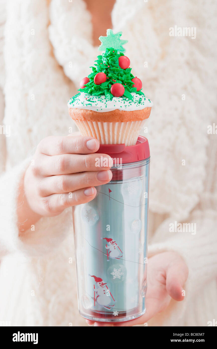 Woman holding cupcake on insulated beaker (Christmas Stock Photo - Alamy