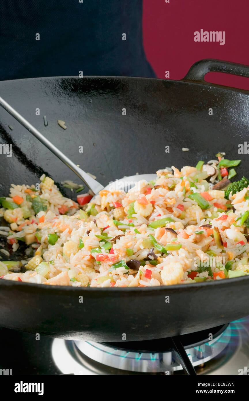 Frying vegetable rice in wok Stock Photo - Alamy