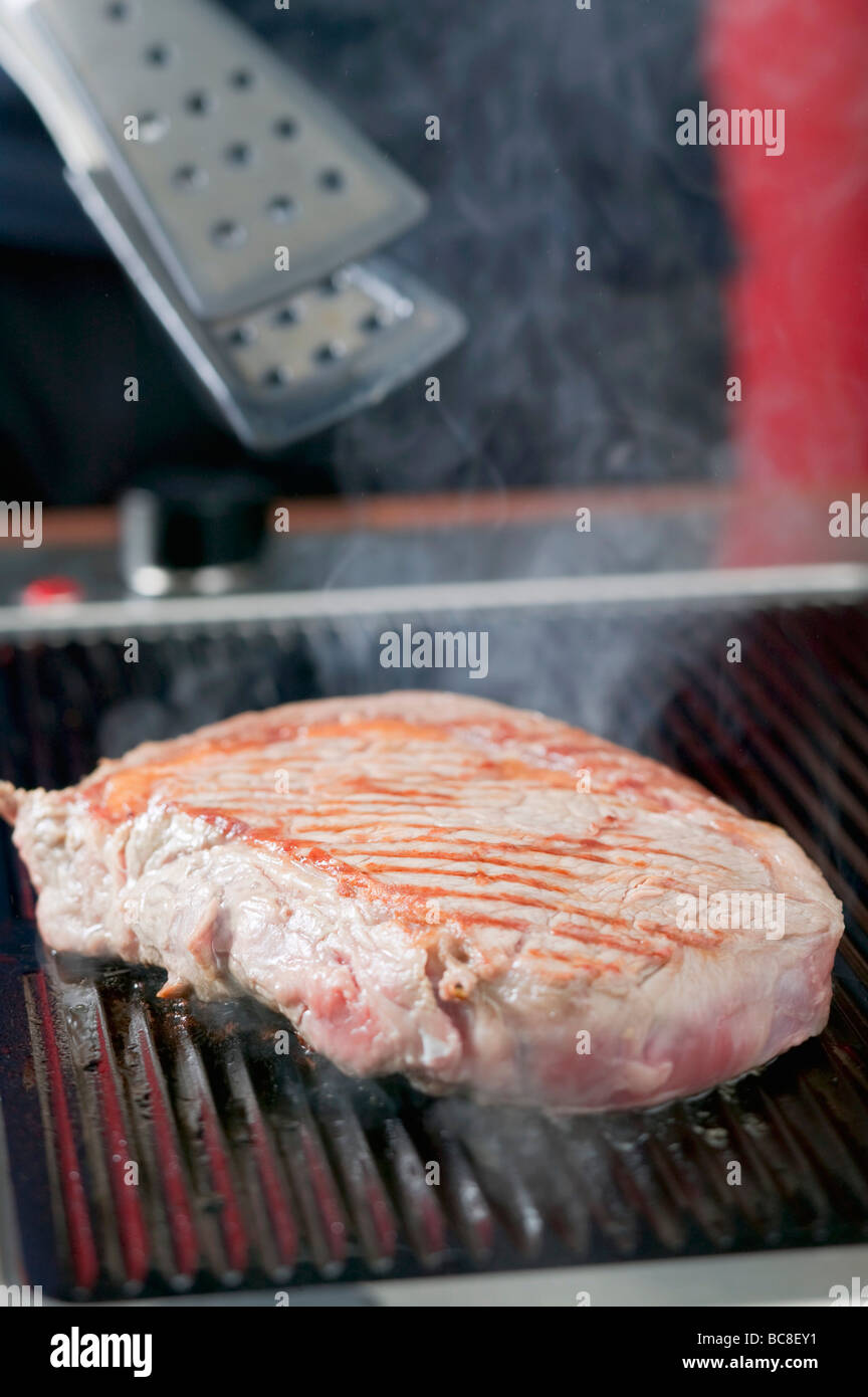 Grilling beef steak Stock Photo - Alamy