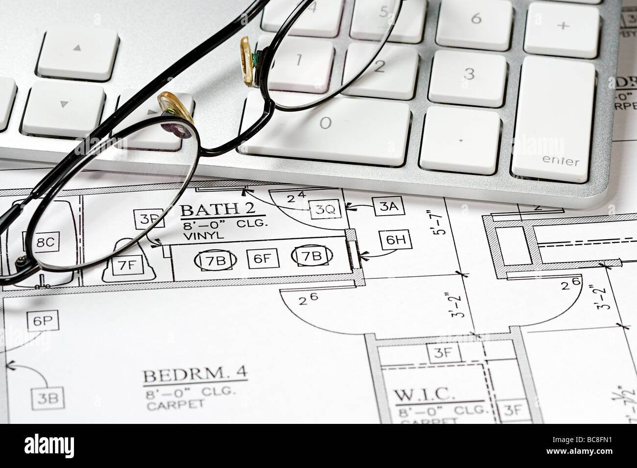 Modern architect using a CAD blueprint and a computer Stock Photo - Alamy