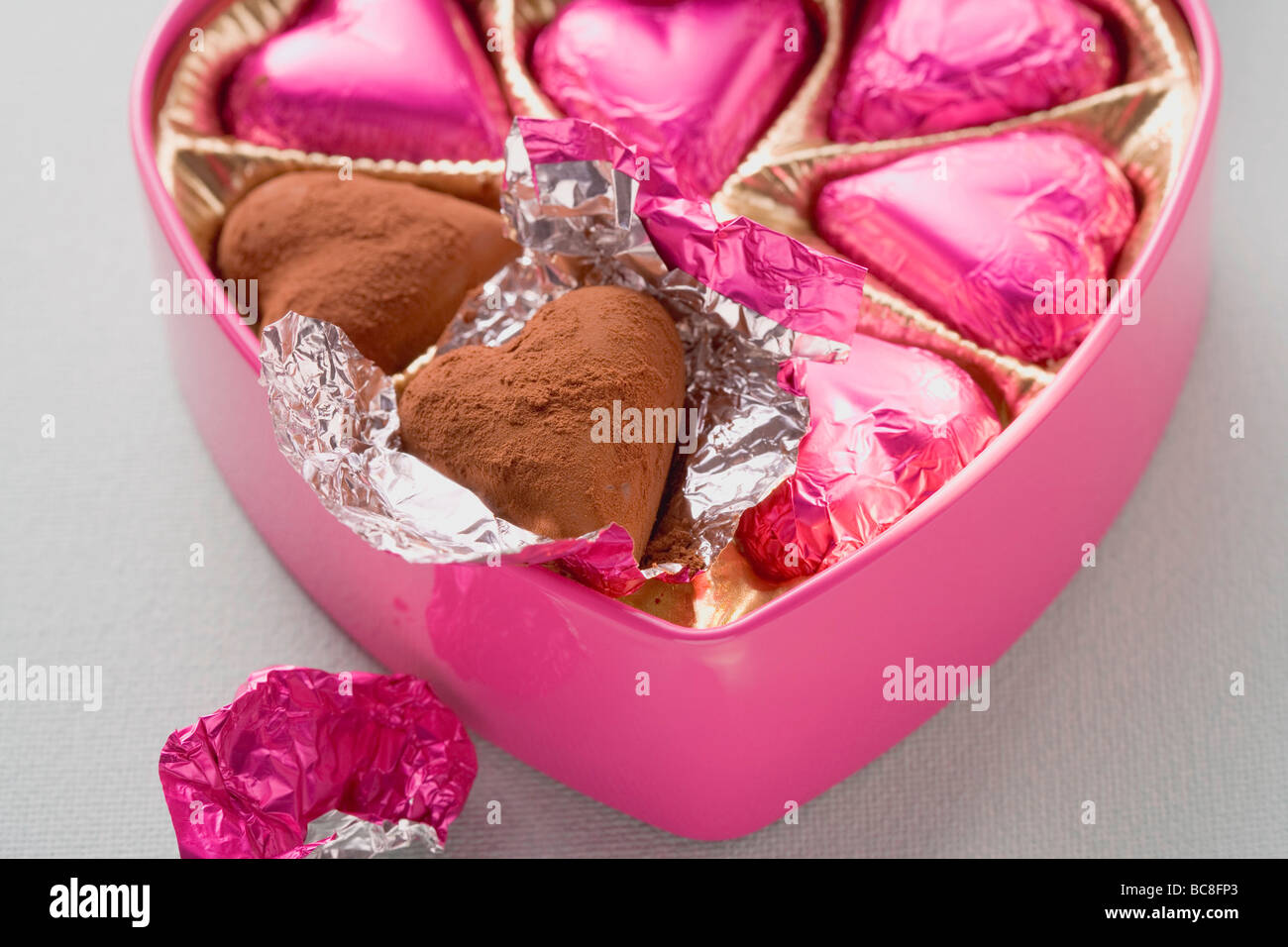 Pink chocolates in heart-shaped box Stock Photo - Alamy