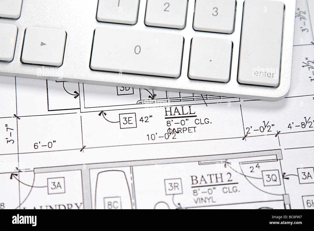 Modern architect using a CAD blueprint and a computer Stock Photo - Alamy