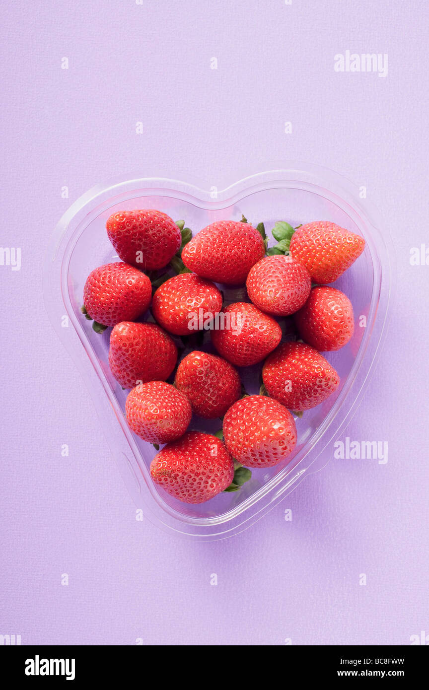 Fresh strawberries in heart-shaped plastic container Stock Photo - Alamy
