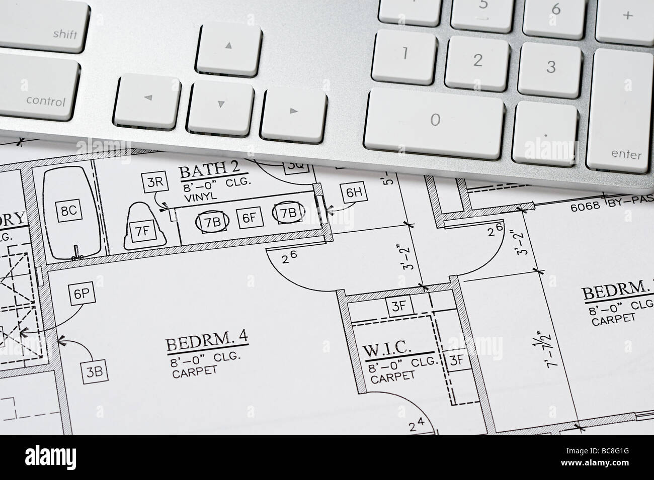 Modern architect using a CAD blueprint and a computer Stock Photo - Alamy