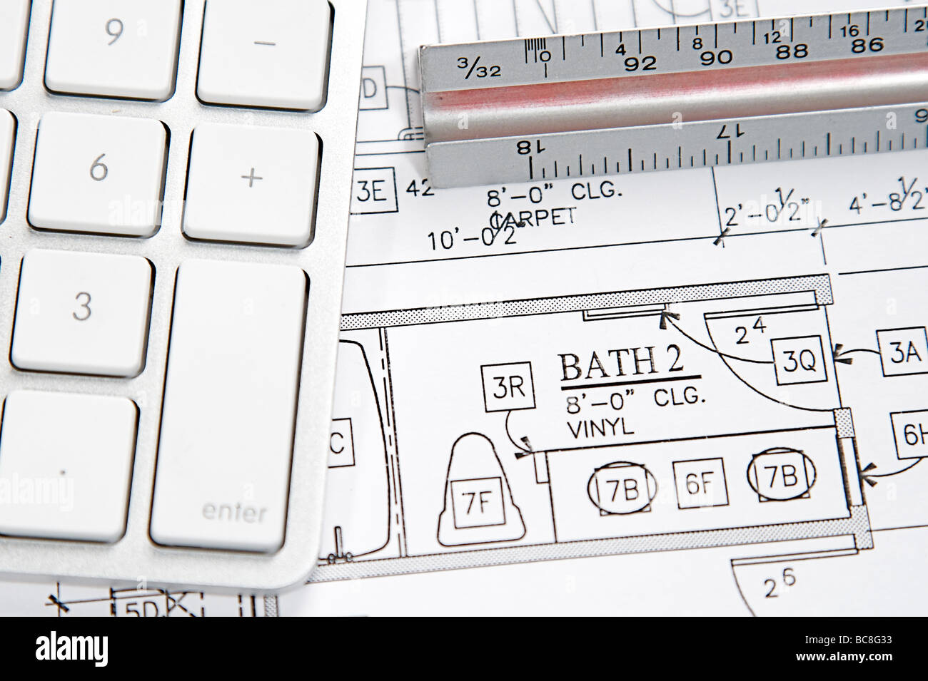 Modern architect using a CAD blueprint and a computer Stock Photo - Alamy