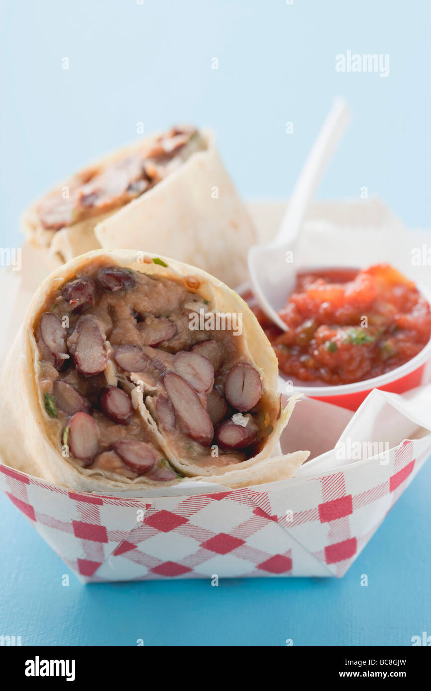 Bean burritos, salsa in cardboard tub Stock Photo - Alamy