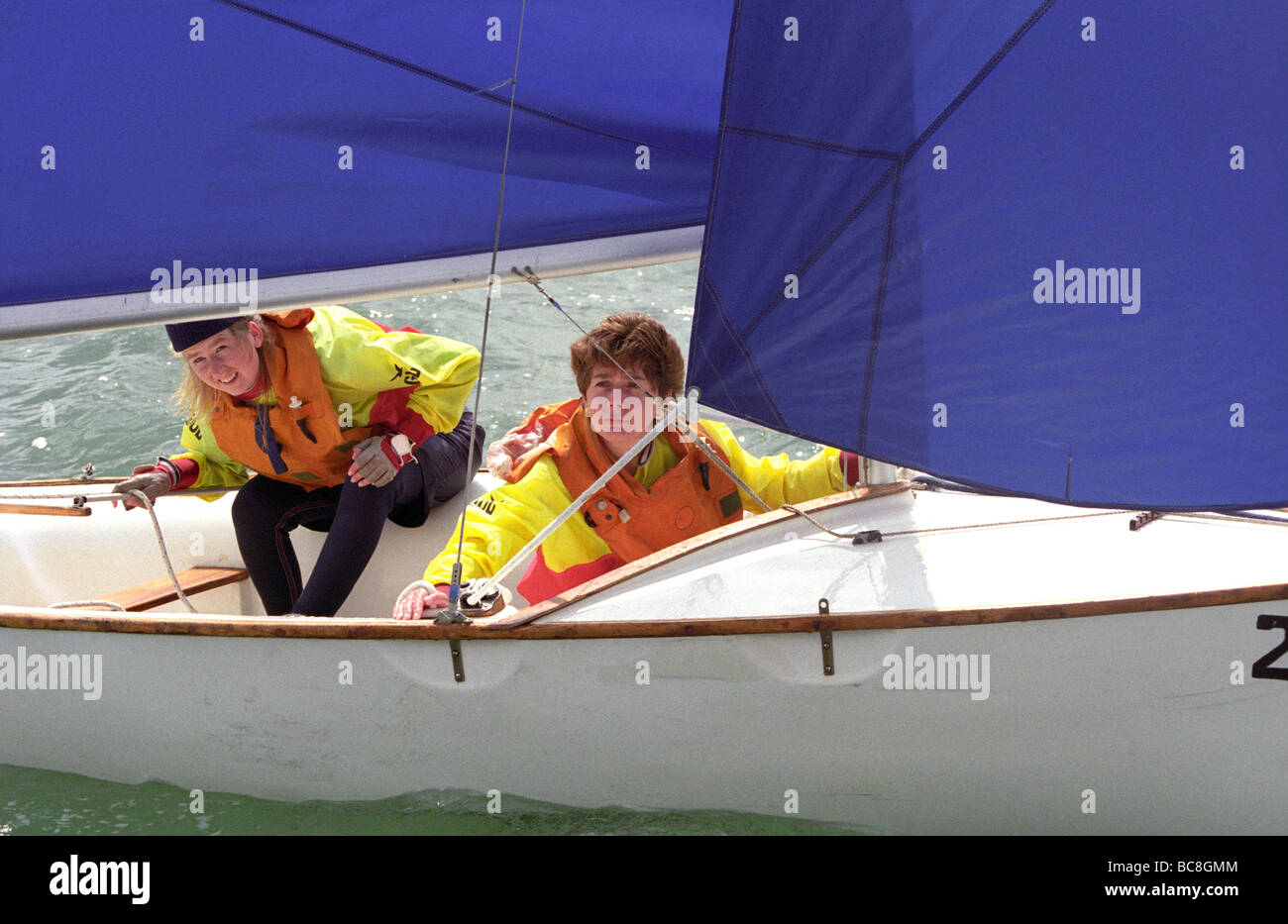 2 female girls sailing in small boat bosons dinghy Stock Photo - Alamy
