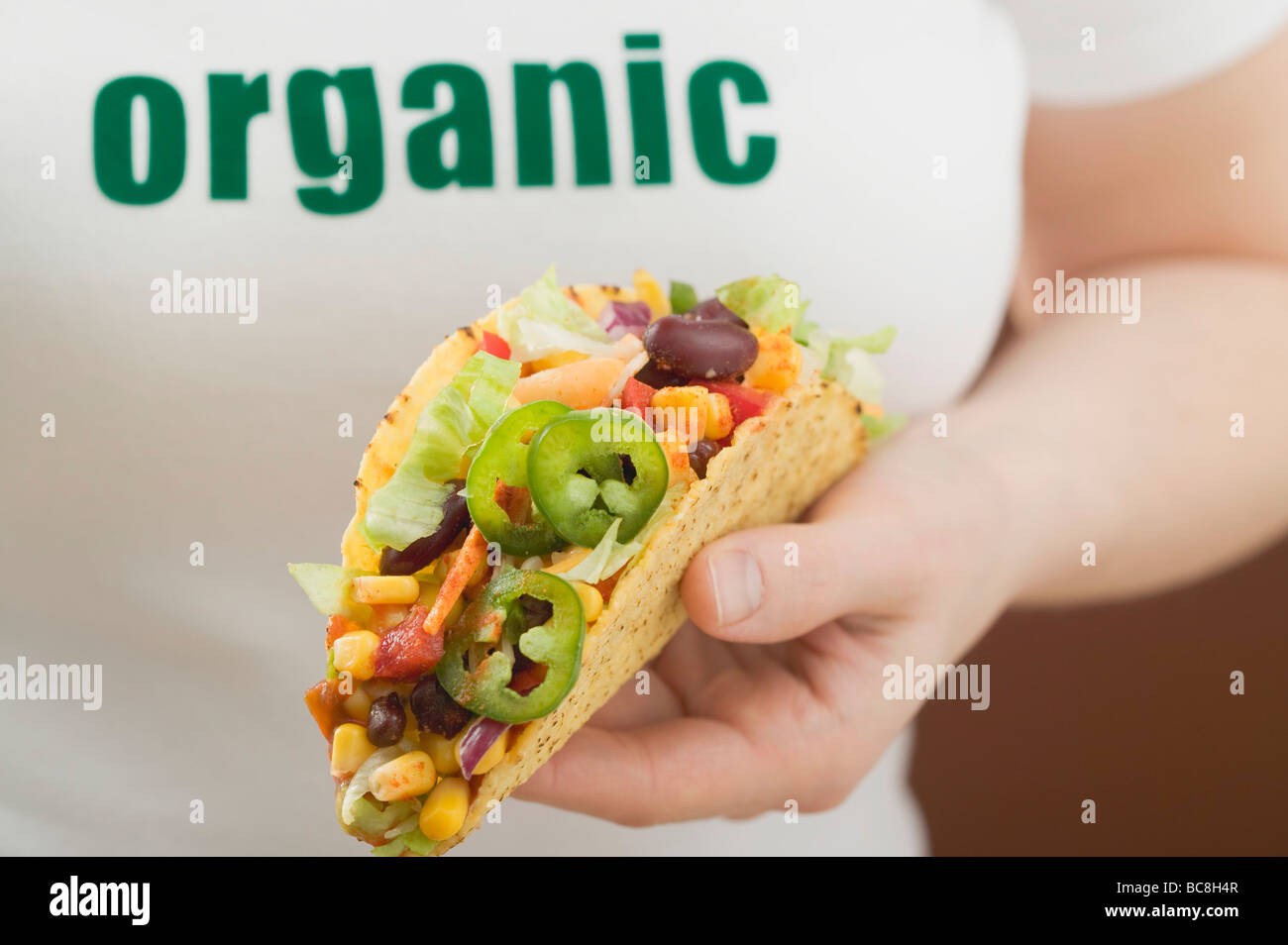 Hand holding vegetable taco Stock Photo - Alamy