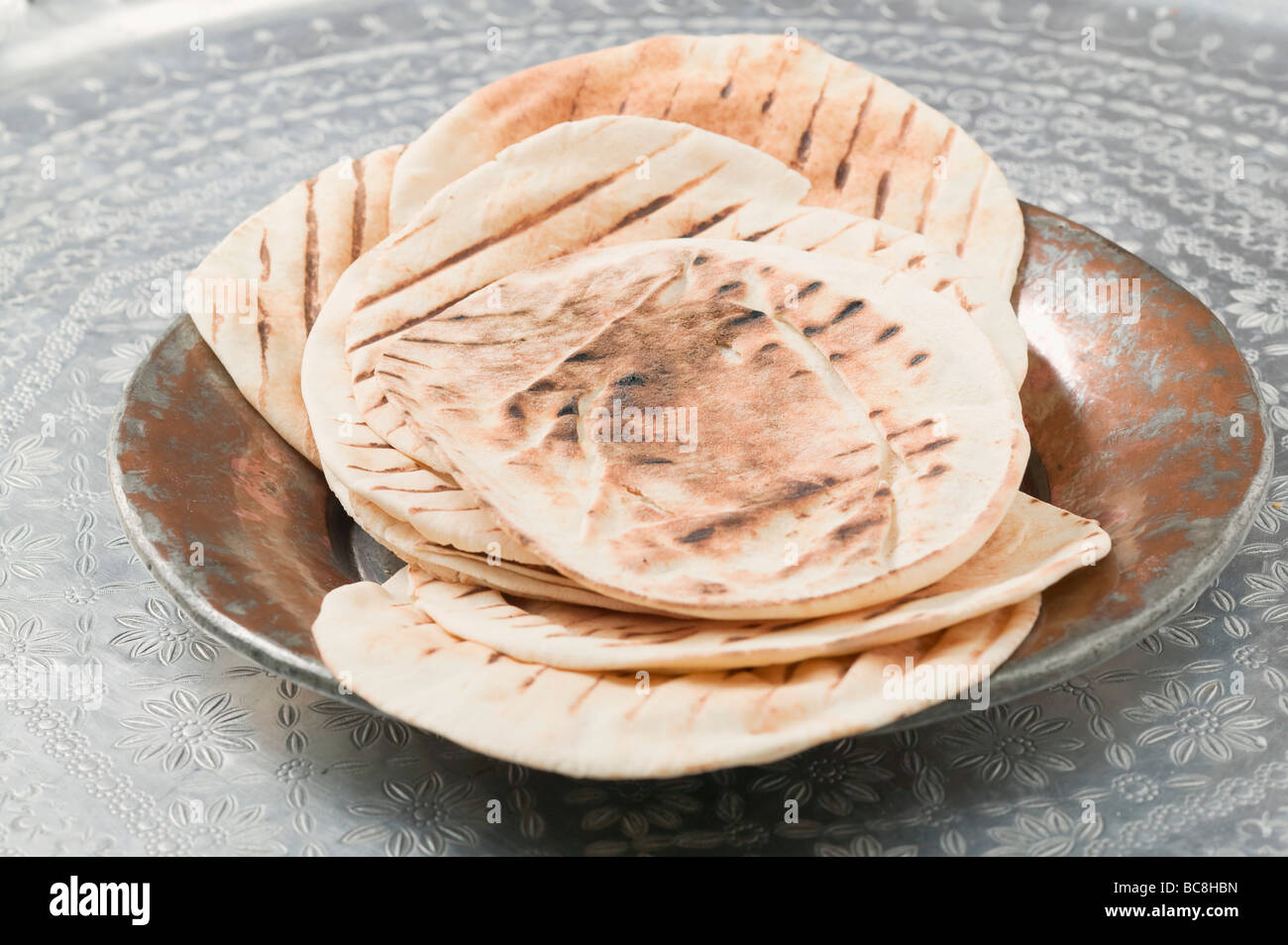 Grilled flatbread on metal plate Stock Photo - Alamy