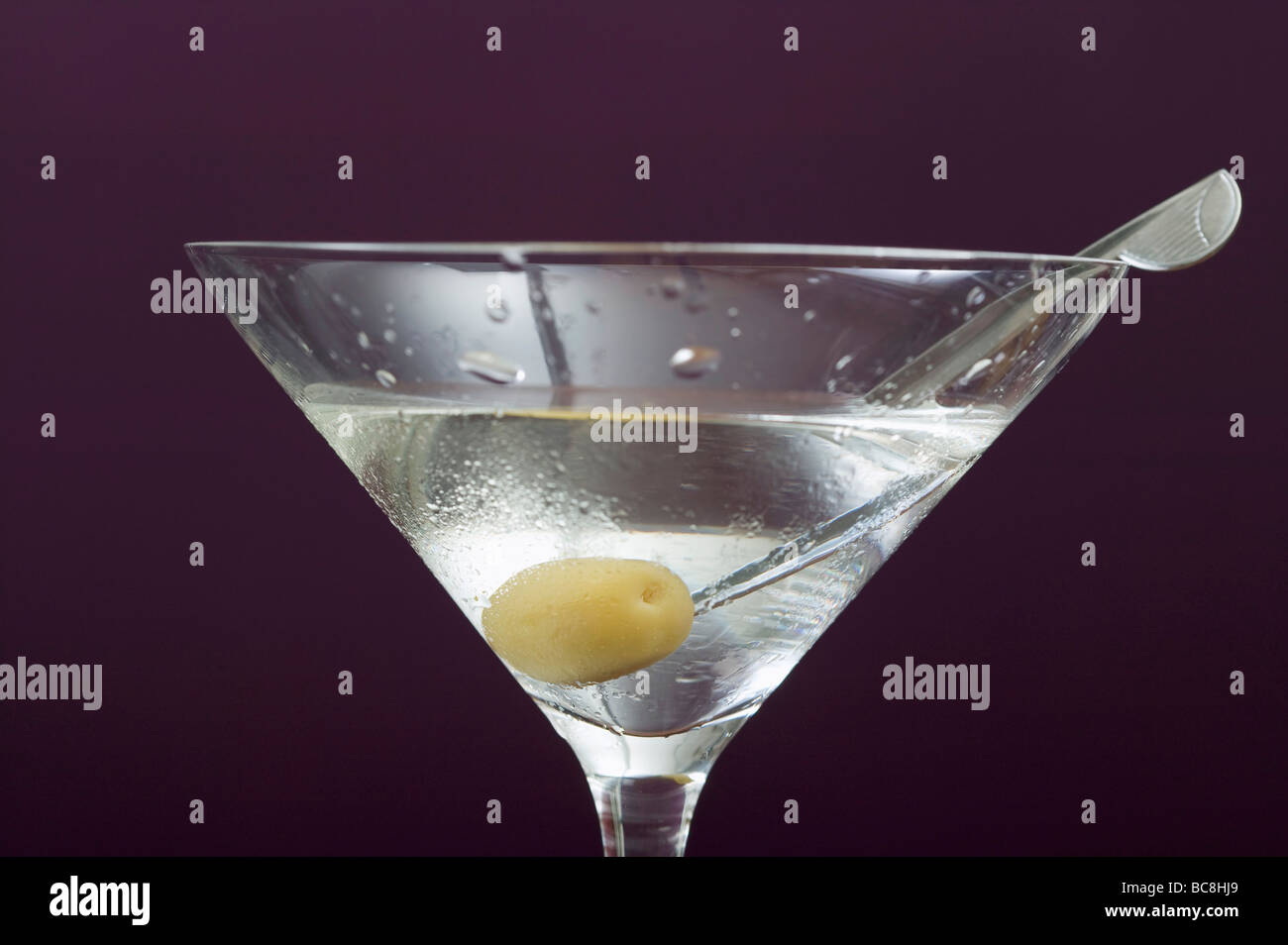 Martini with olive in glass Stock Photo - Alamy