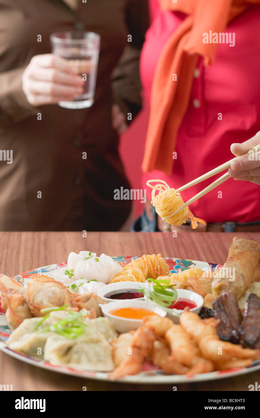 Two women with Asian appetiser platter Stock Photo - Alamy