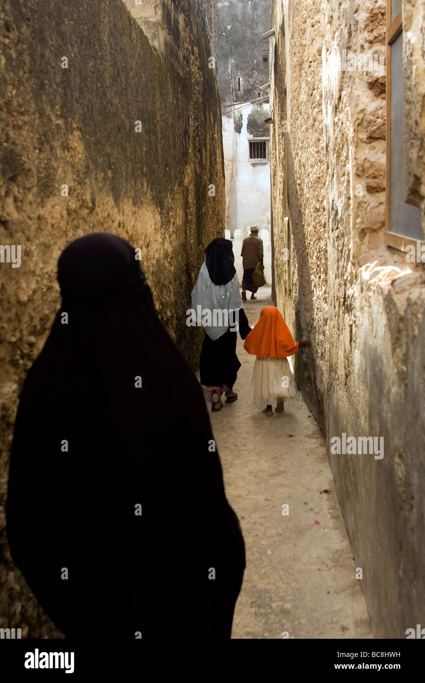 People walking down narrrow streets of Lamu town - Lamu Island, Kenya ...