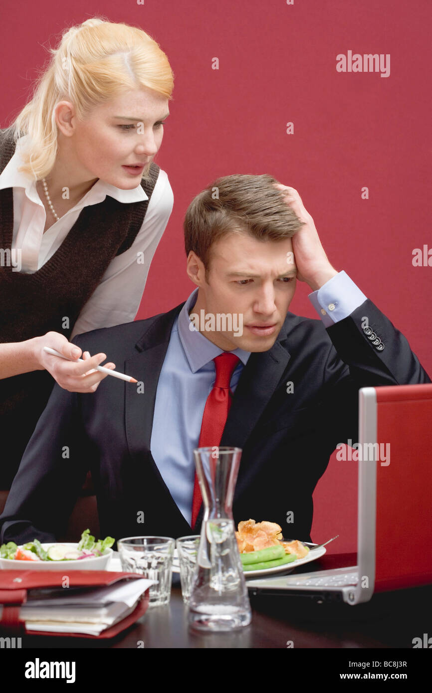 Office colleagues with computer probems working through lunch Stock ...