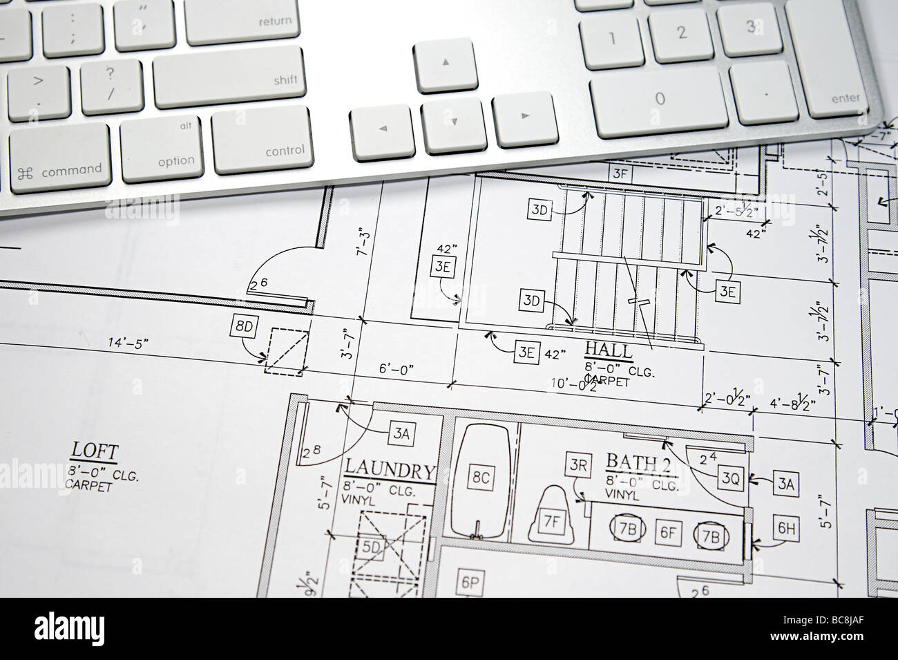 Modern architect using a CAD blueprint and a computer Stock Photo - Alamy