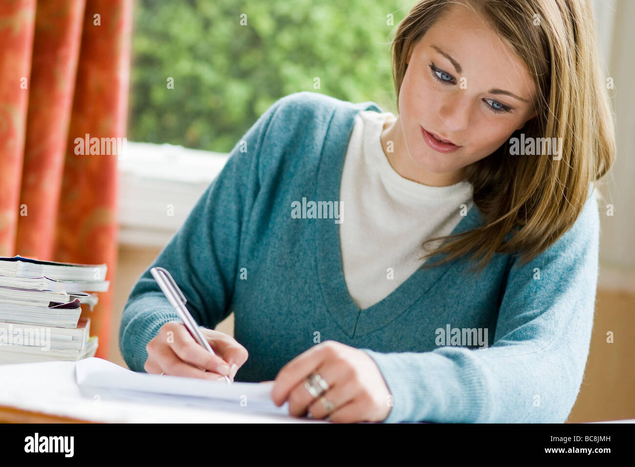 young female teacher marking work Stock Photo - Alamy