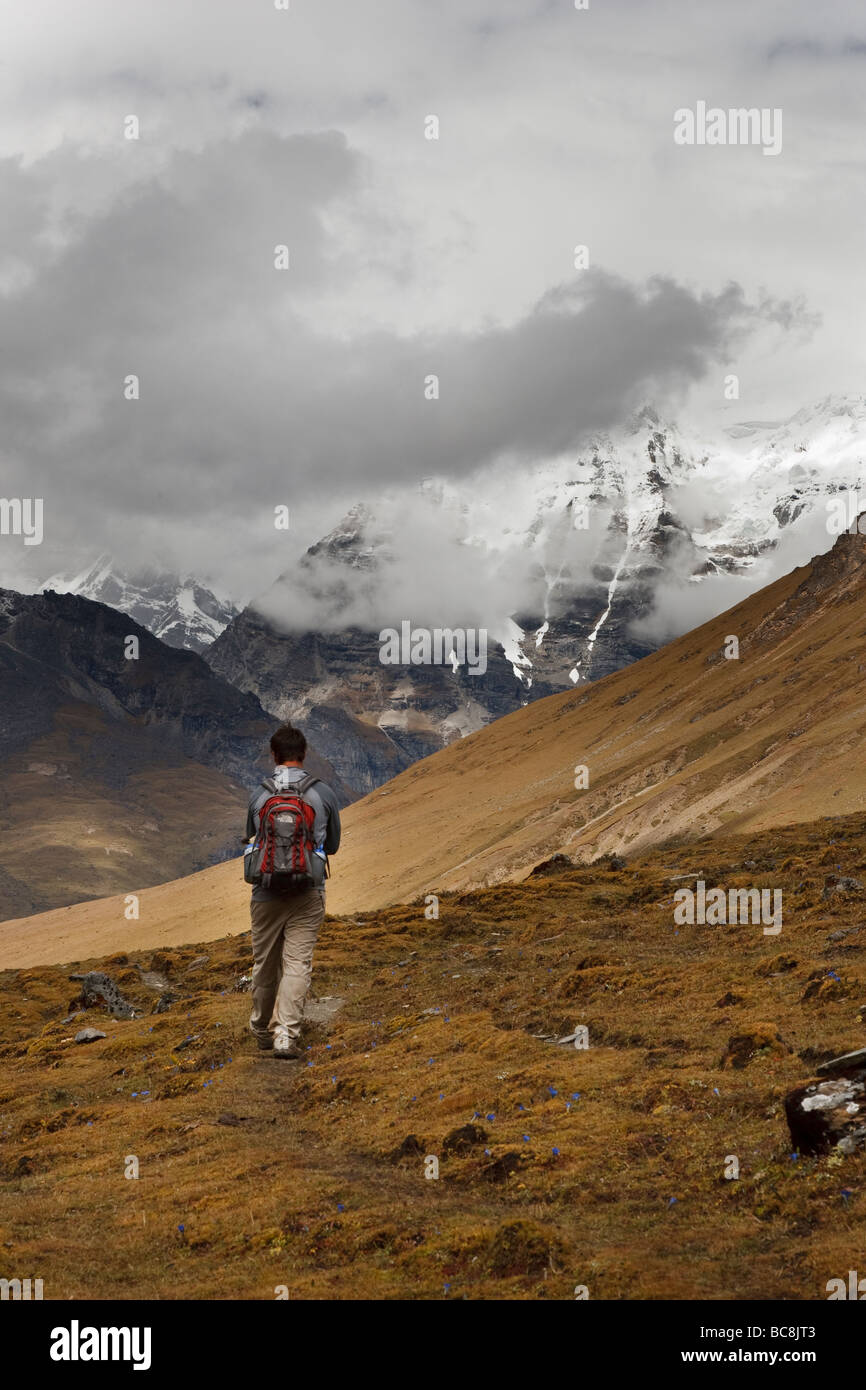 A man walking a trail in Bhutan leading through the high country Stock ...