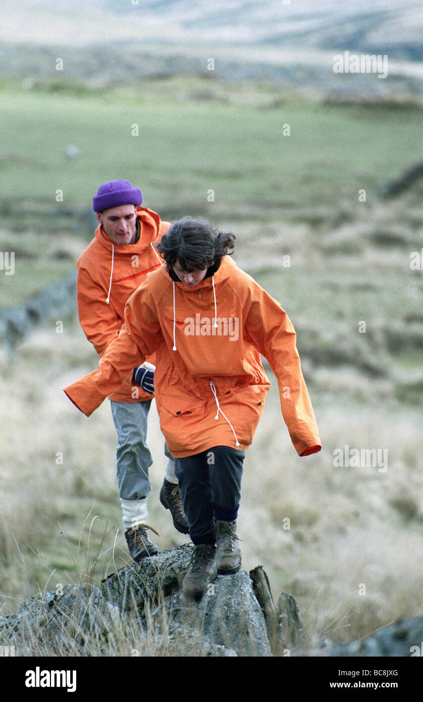 2 Young people orienteering on Dartmoor National Park. boy girl man ...