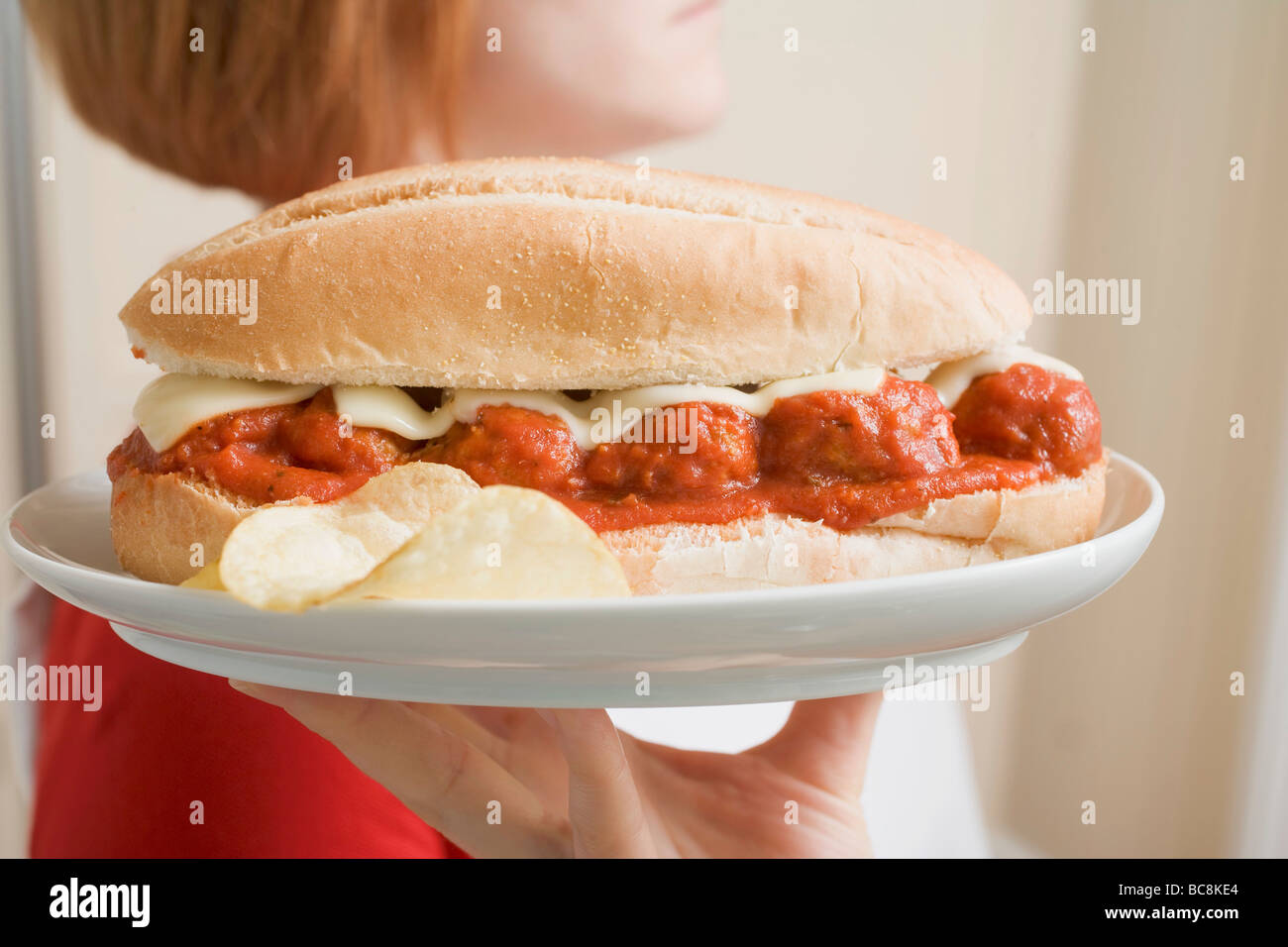 Woman serving a meatball sandwich Stock Photo - Alamy