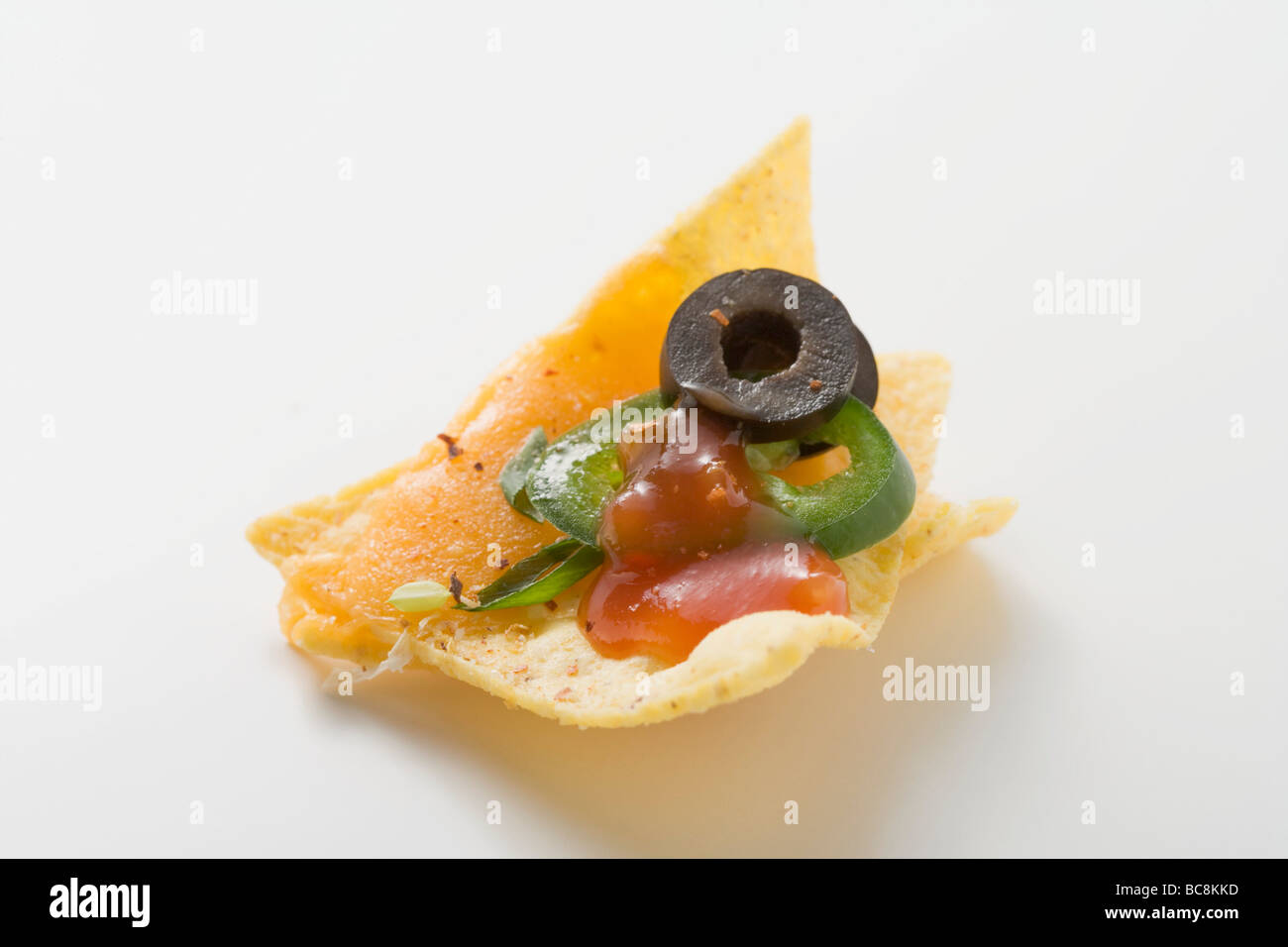 Nacho with cheese, olive, chilli ring and ketchup Stock Photo - Alamy