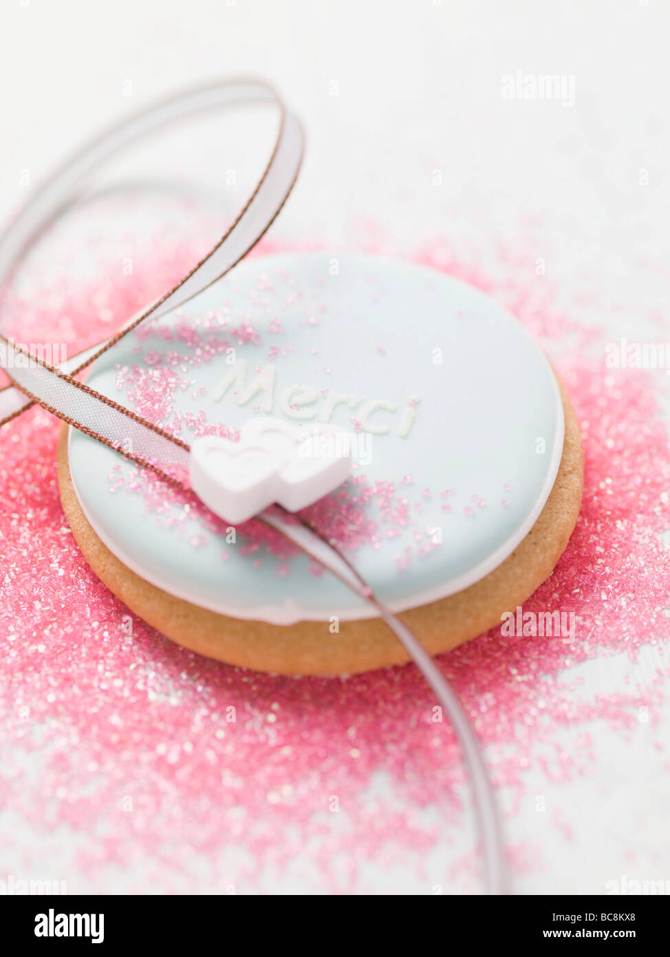 Biscuit with blue icing, sugar hearts and the word Merci Stock Photo ...
