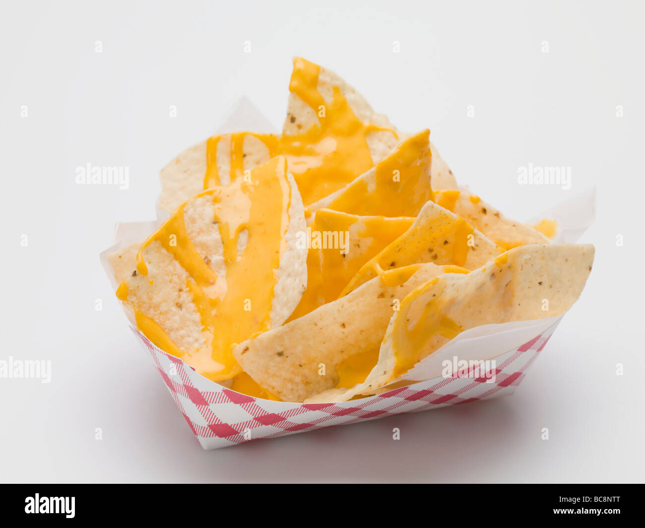 Nachos with cheese sauce in a paper dish Stock Photo - Alamy