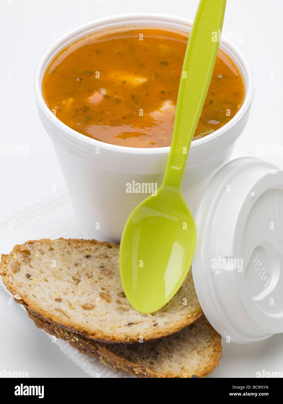 Tomato & vegetable soup in polystyrene cup, bread beside it Stock Photo ...