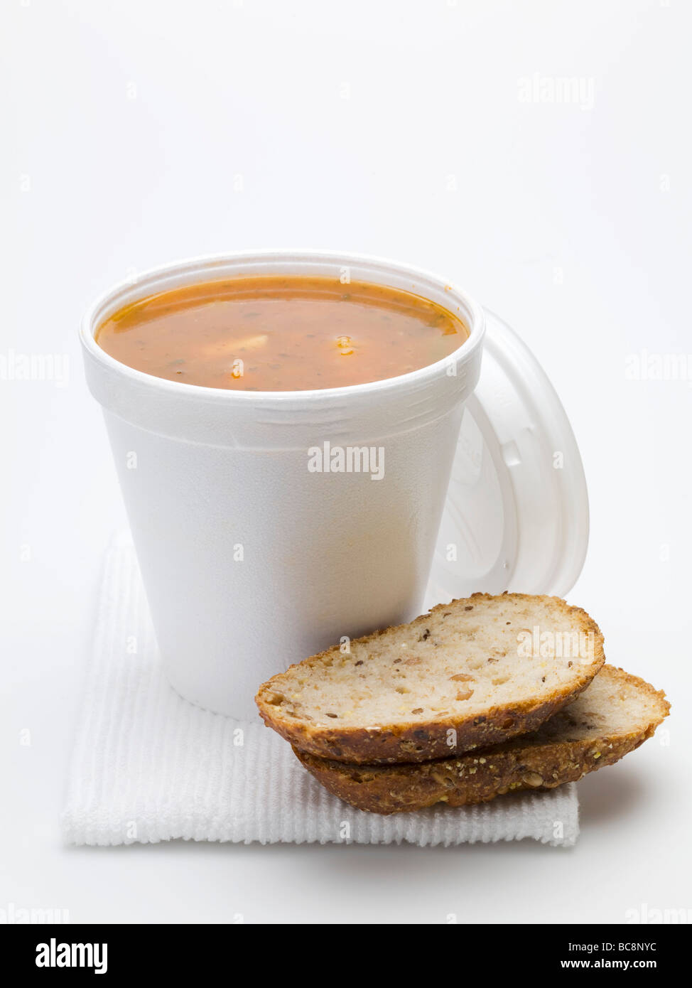 Tomato & vegetable soup in polystyrene cup, bread beside it Stock Photo ...