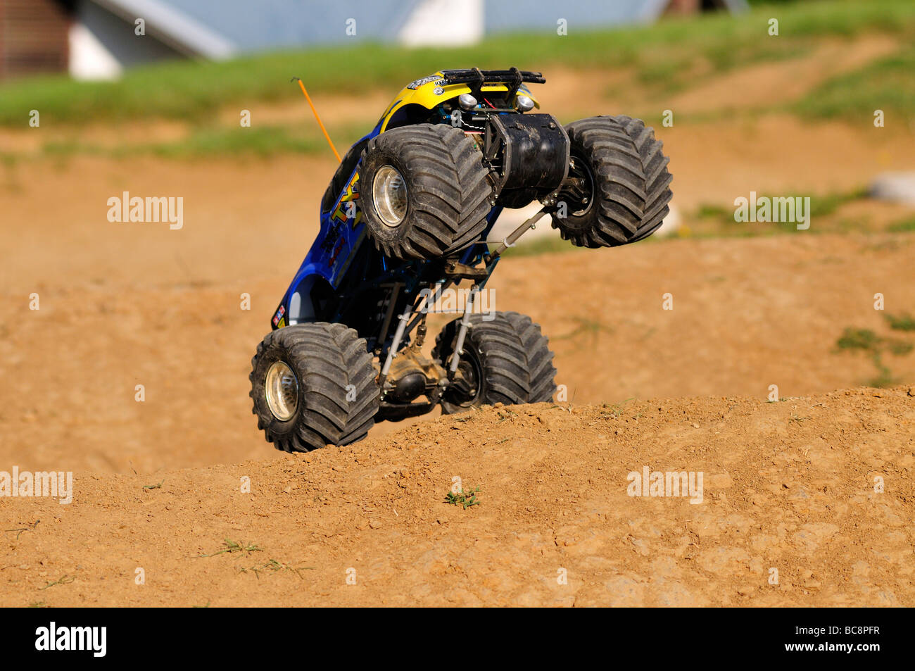 Tamiya toy radio controlled Monster Truck speeding and jumping Stock ...