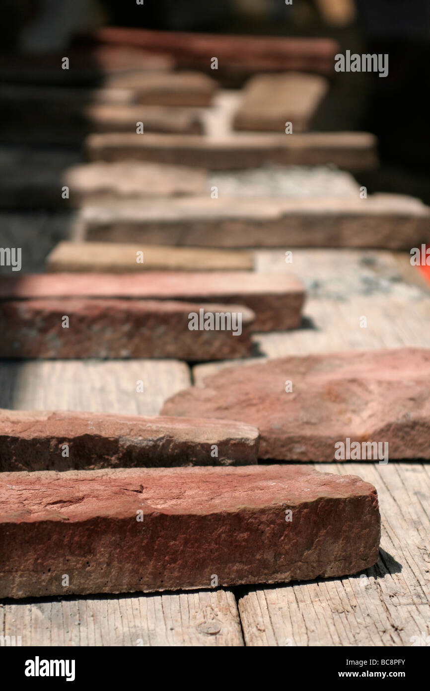 Stonemasons bench with workstones Stock Photo - Alamy