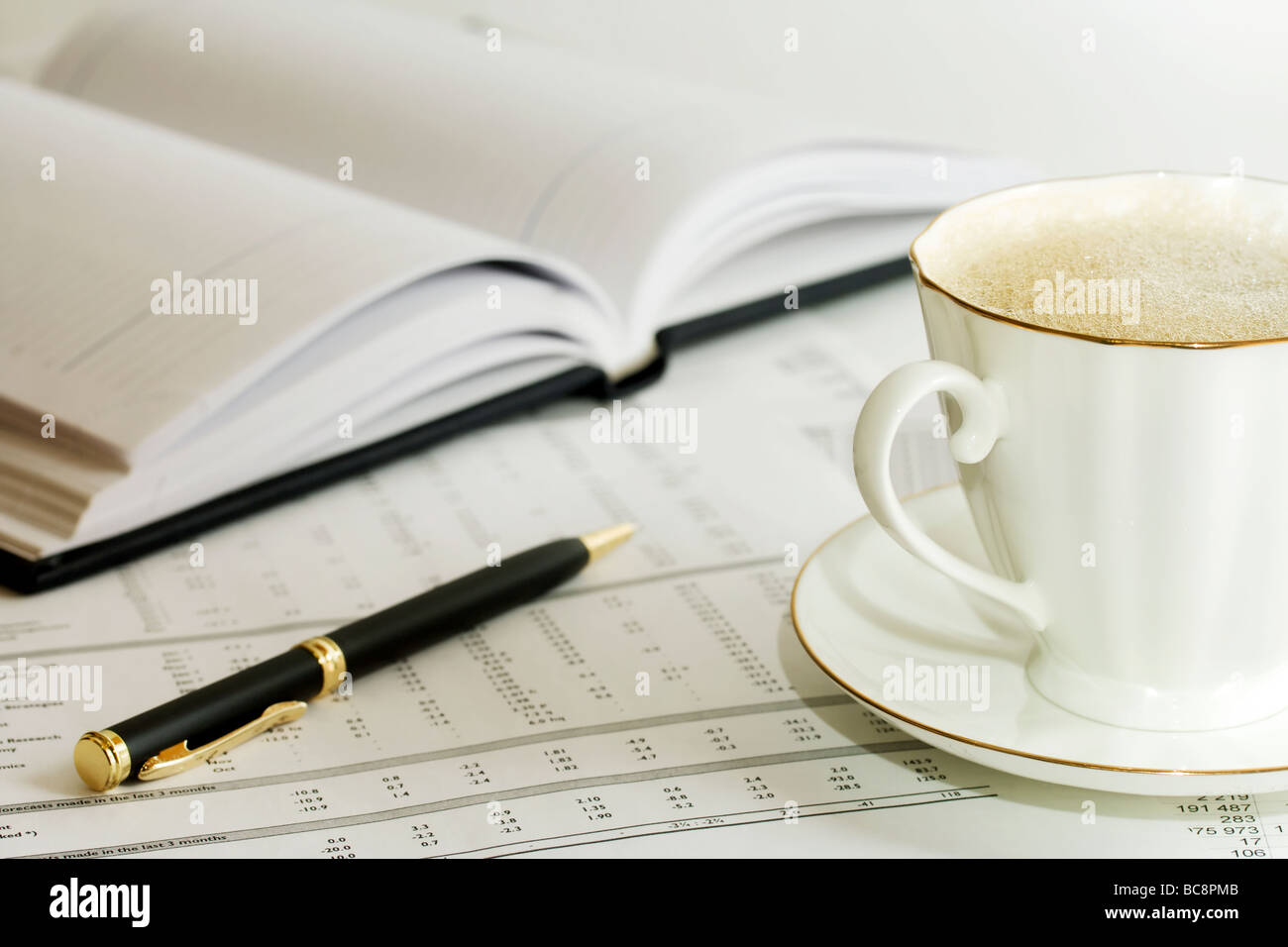 Cup of coffee and financial accounting Stock Photo - Alamy