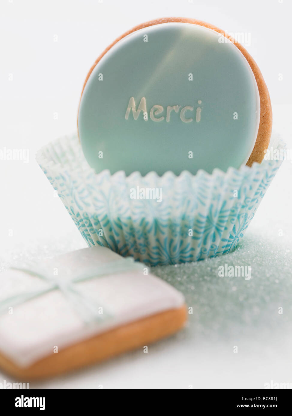 Biscuit with the word Merci in paper case Stock Photo - Alamy