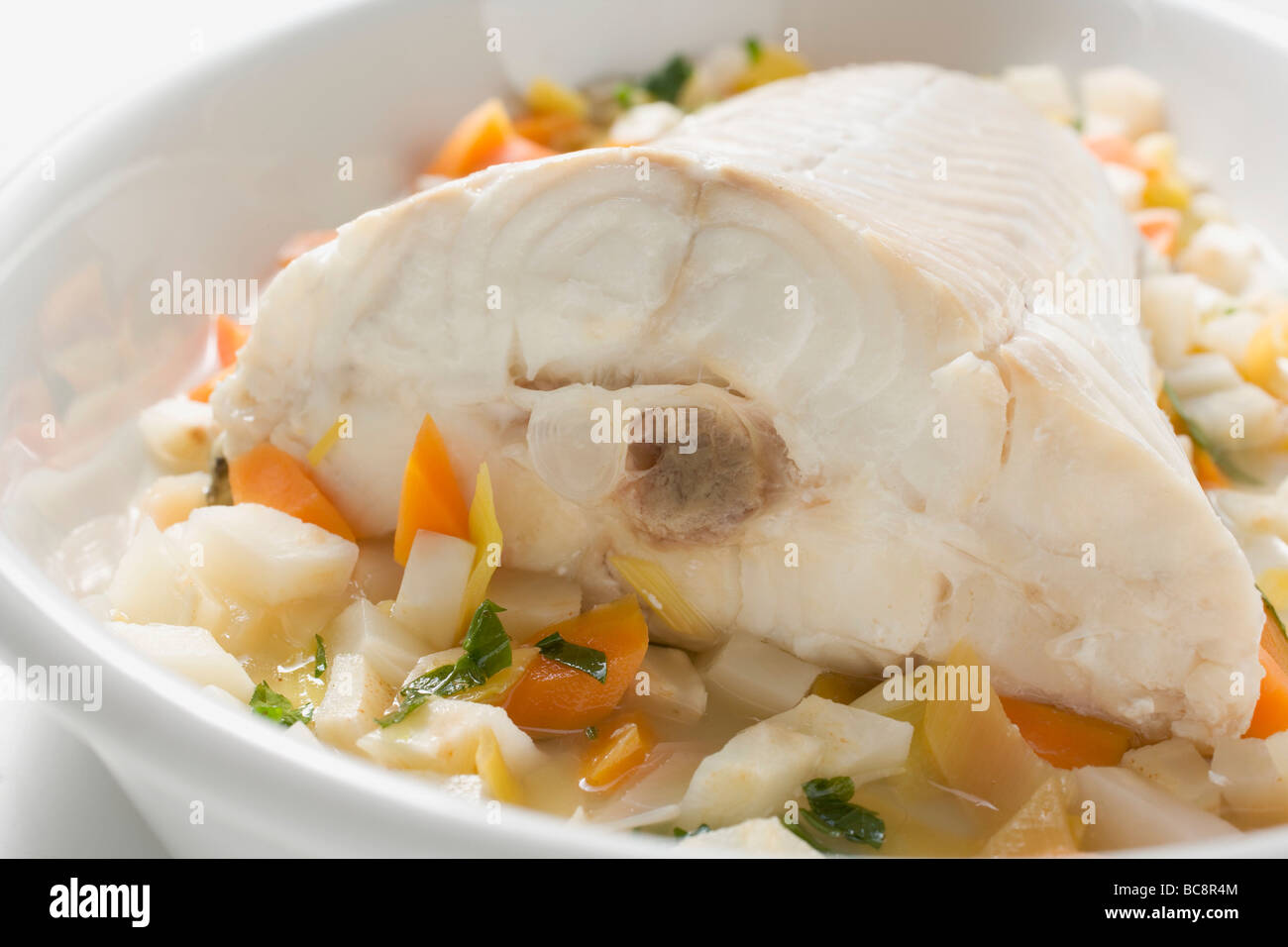 Fish on root vegetables Stock Photo - Alamy