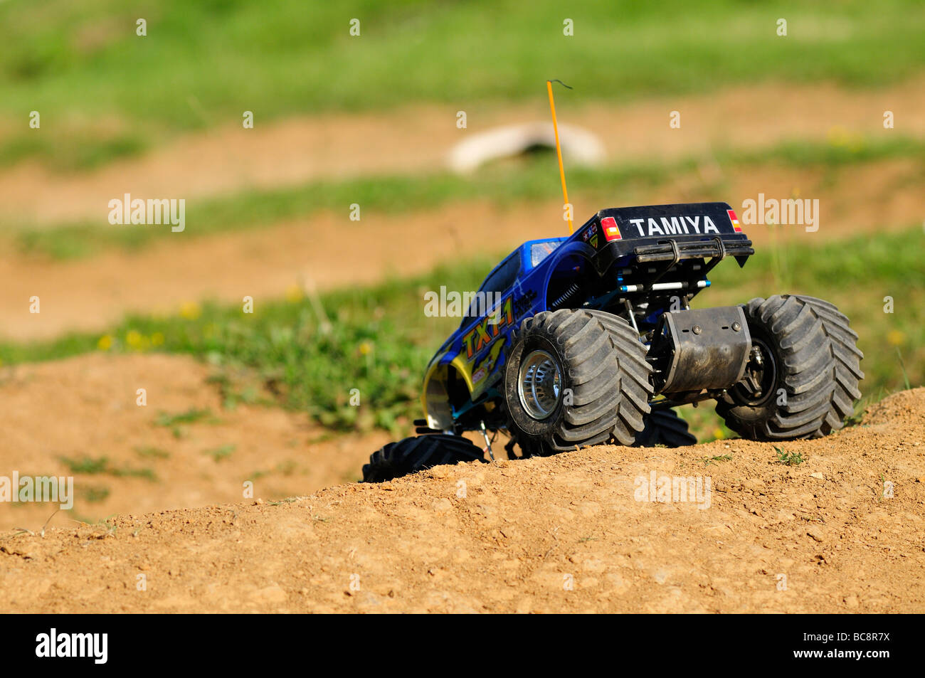 Tamiya toy radio controlled Monster Truck speeding and jumping Stock ...