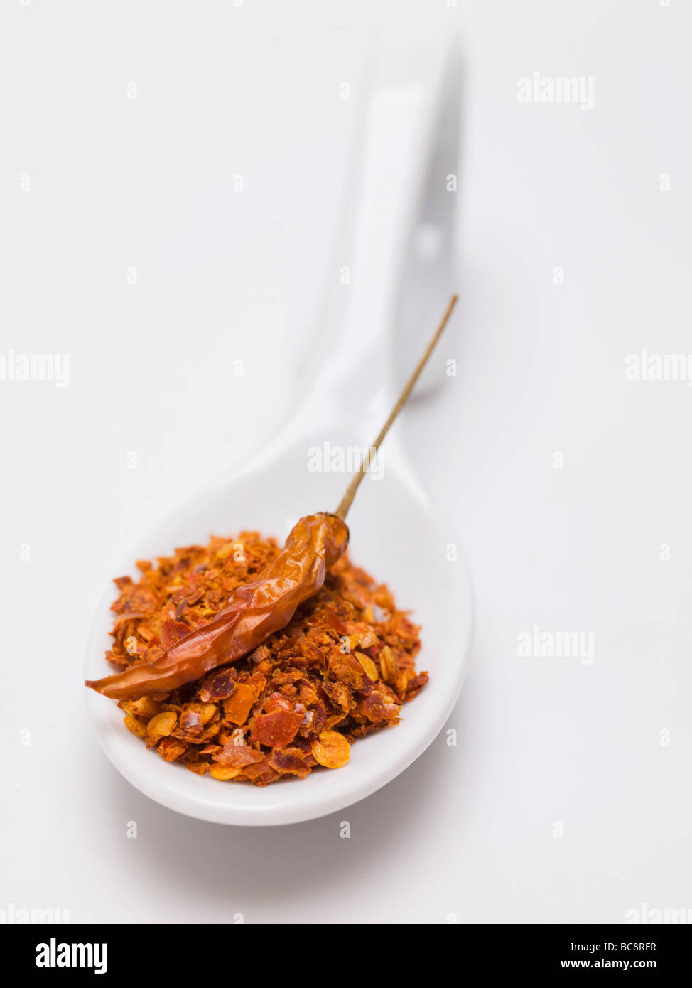 Chilli flakes and dried chilli on spoon Stock Photo - Alamy
