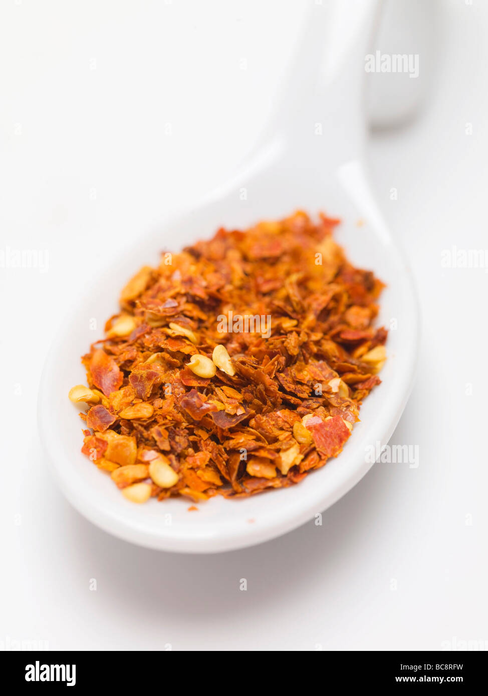 Chilli flakes on spoon (close-up Stock Photo - Alamy