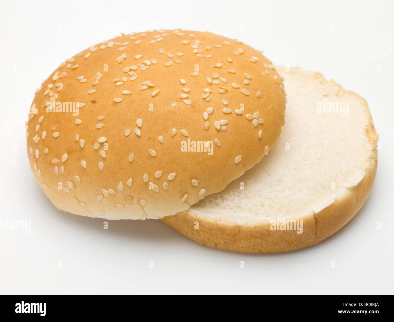 A hamburger bun with sesame seeds, split Stock Photo - Alamy