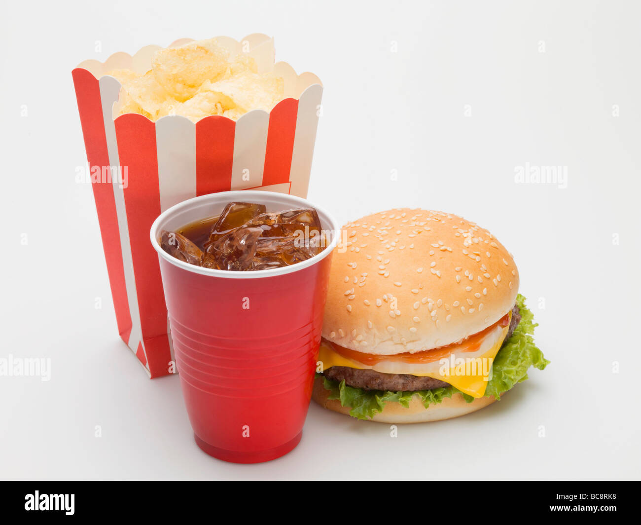Cheeseburger, crisps and cola Stock Photo - Alamy