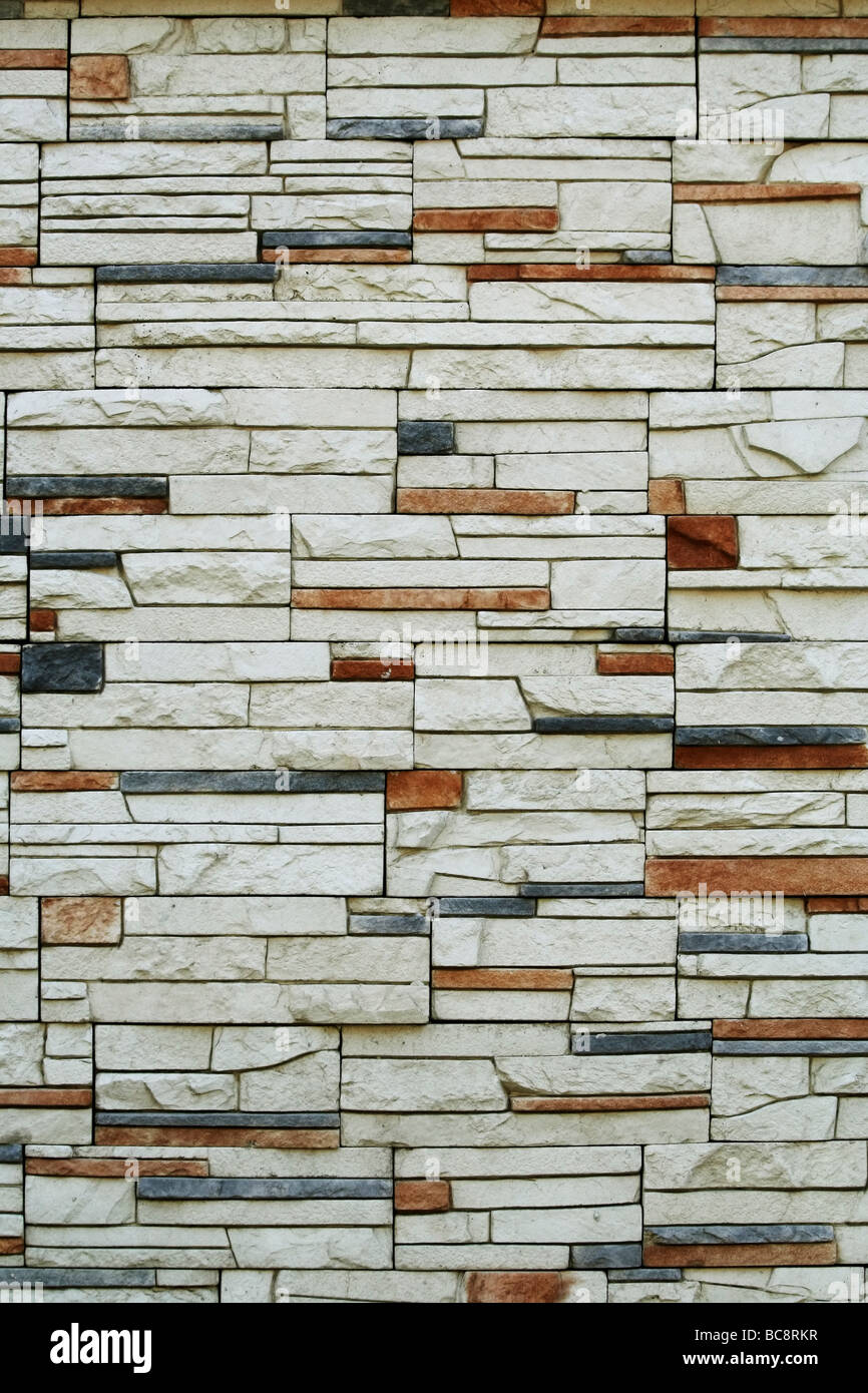 Stone wall of a stacked brick facade Stock Photo - Alamy