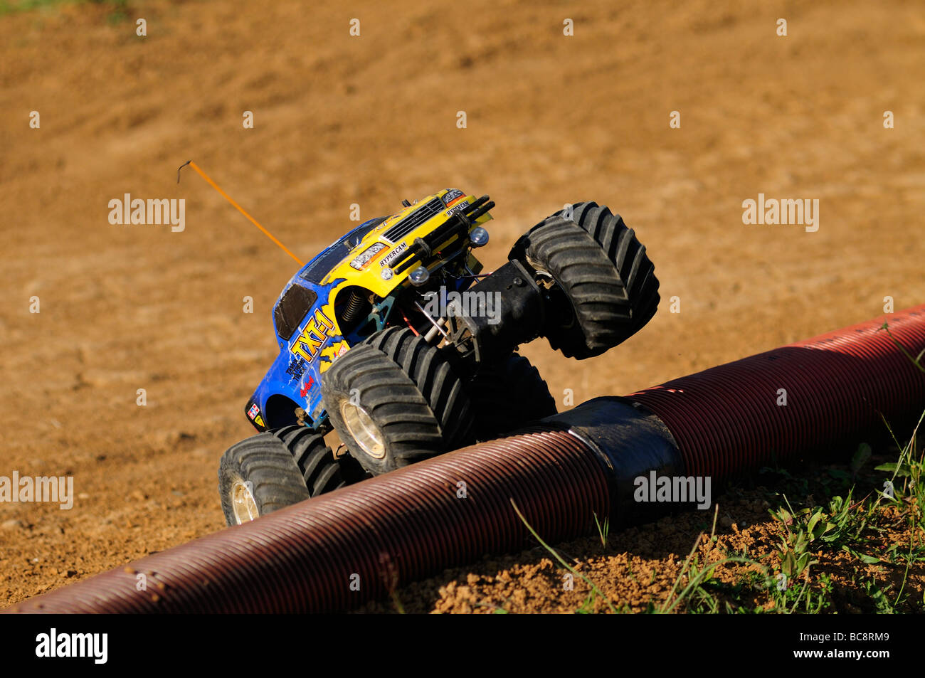 Tamiya toy radio controlled Monster Truck speeding and jumping Stock ...